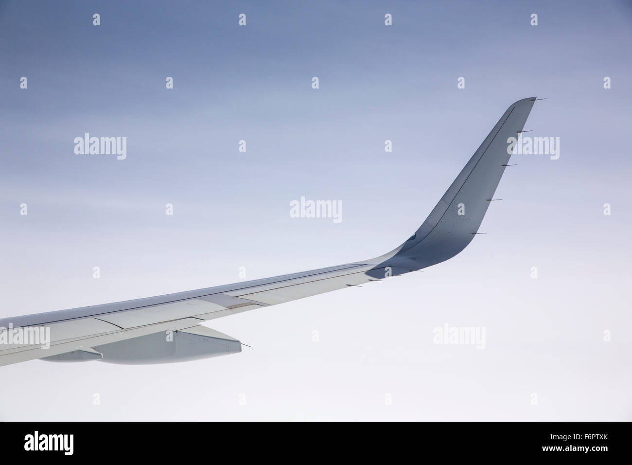 Airplane wing under clear sky Stock Photo - Alamy