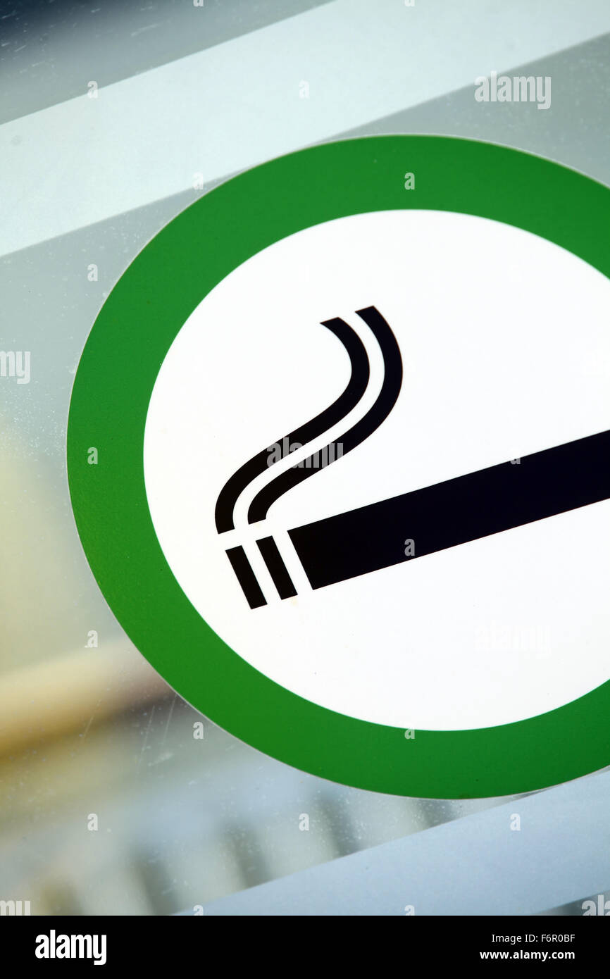 Picture of a sign marking the designated smoking area on a window Stock ...
