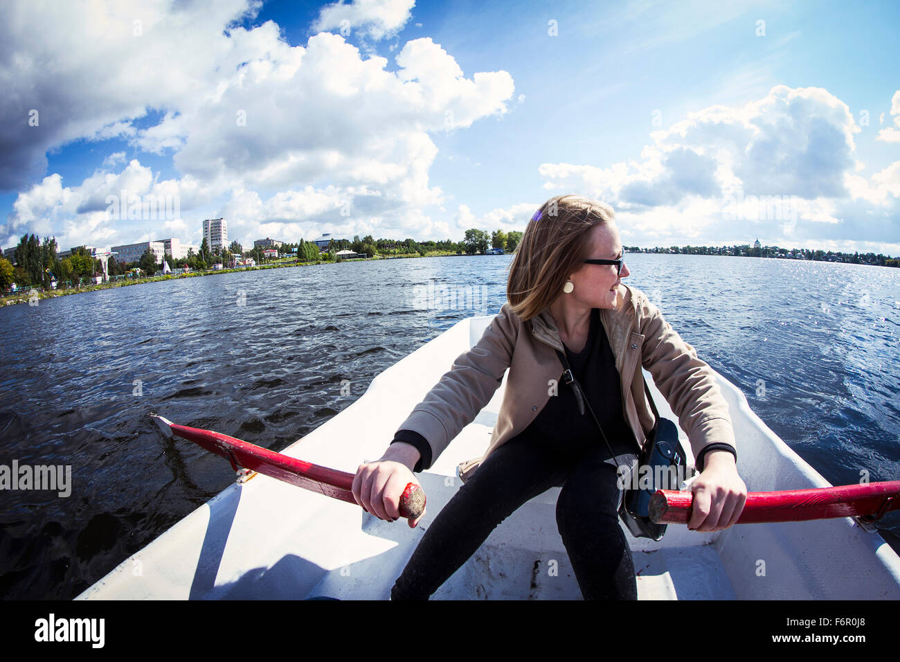 Caucasian woman rowing boat Stock Photo - Alamy