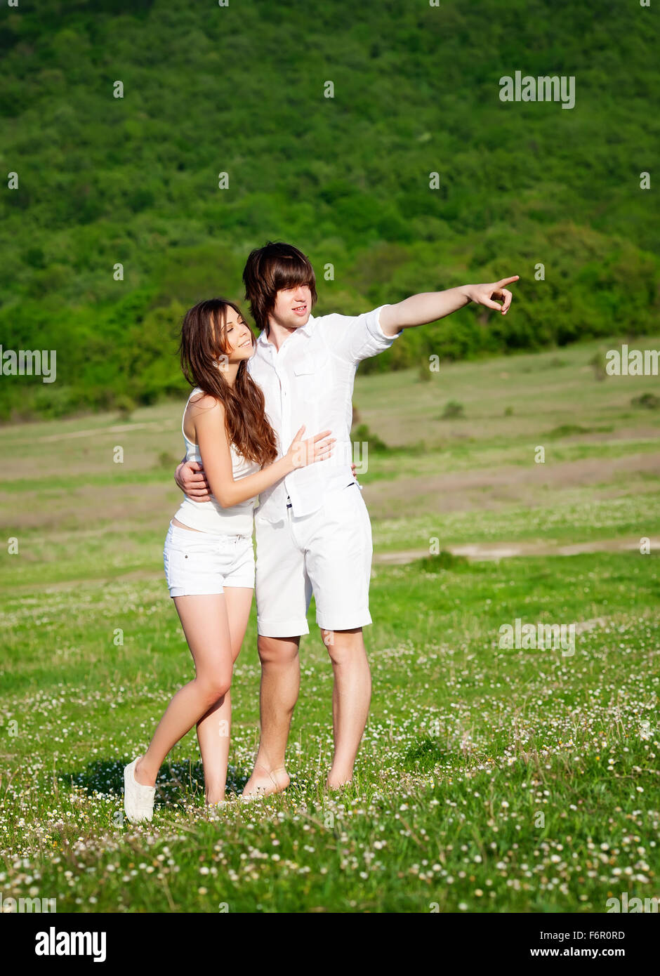 Two lovers playing on the grass meadow Stock Photo - Alamy