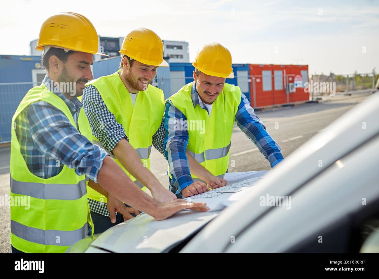 close up of builders with blueprint on car hood Stock Photo - Alamy