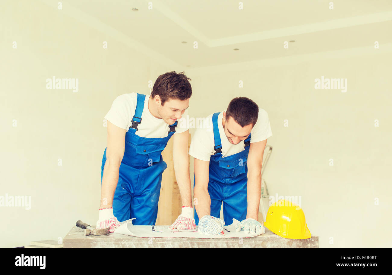 group of builders with blueprint Stock Photo - Alamy