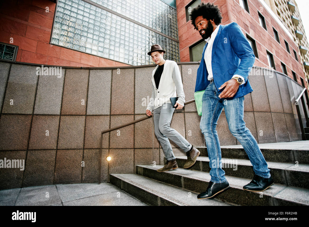 Businessmen talking on steps Stock Photo - Alamy