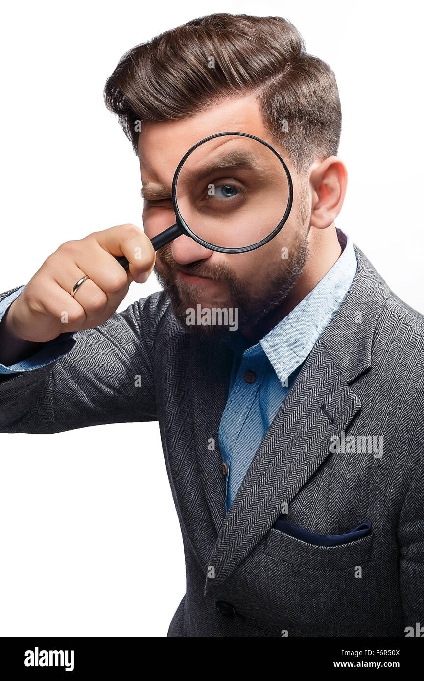 Man with magnifying glass on white background Stock Photo - Alamy