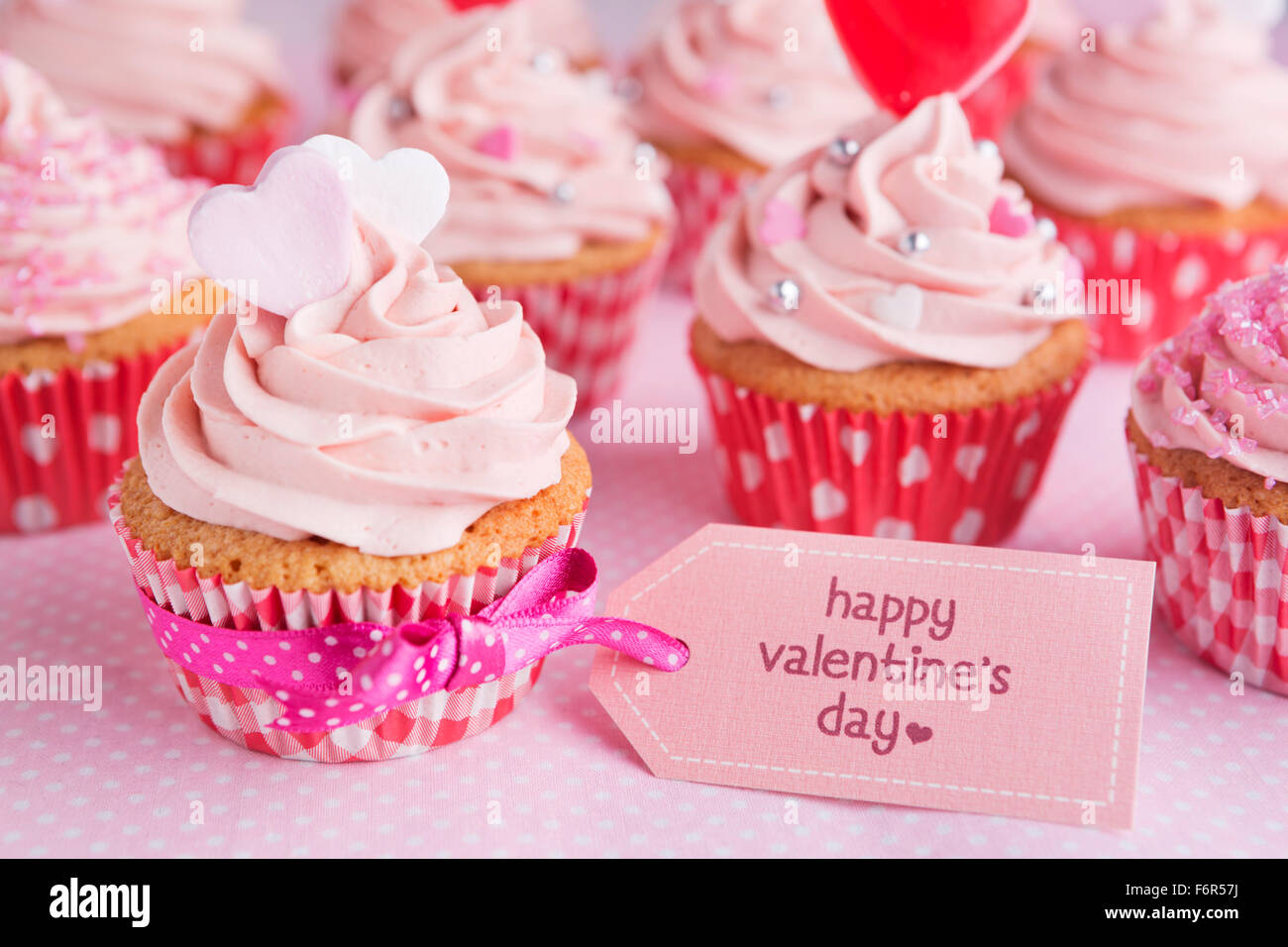 Pink Valentine cupcakes with the words 'Happy Valentine's day' on a tag ...