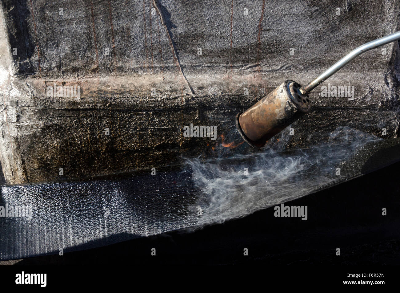 flame during welding of a waterproofing membrane on a roof Stock Photo ...