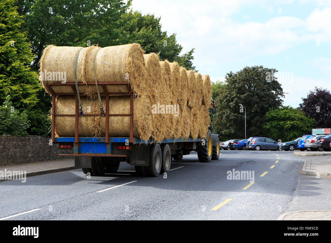 Tractor transporting straw bales in irish countryside Stock Photo - Alamy