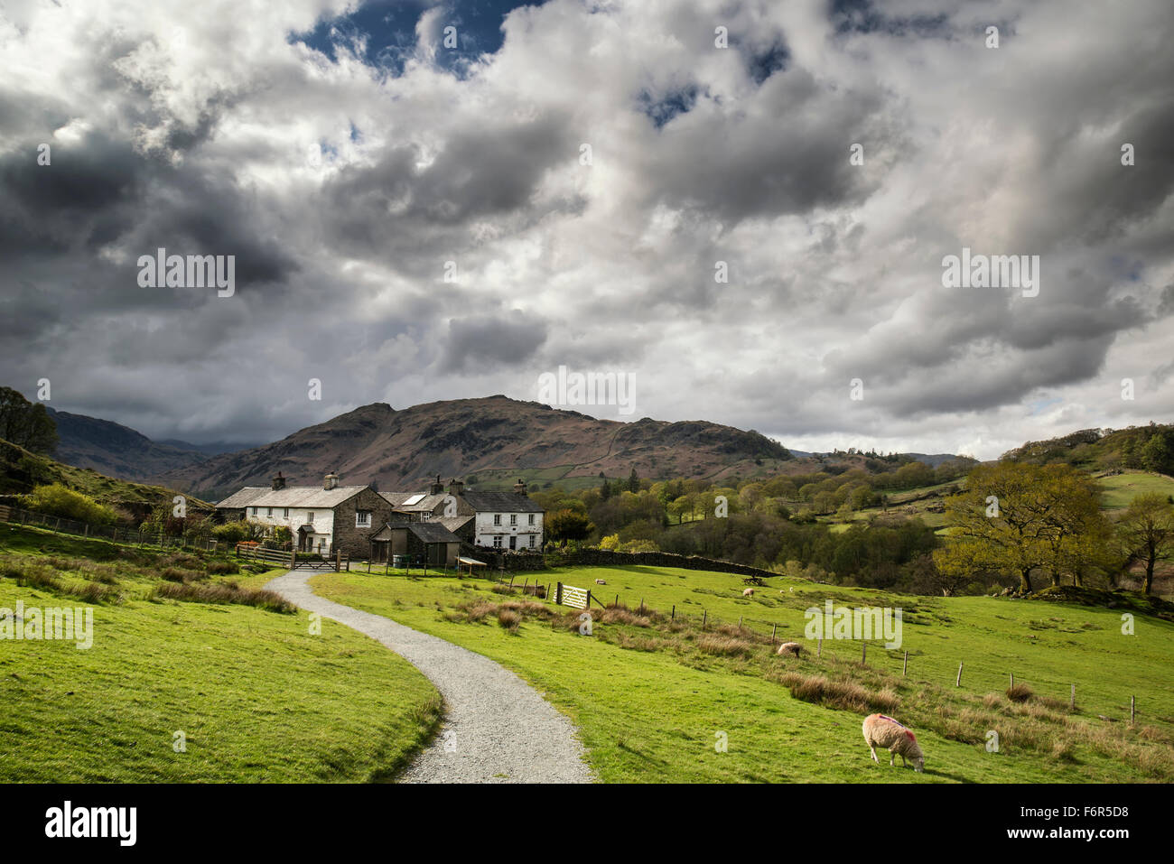 Beautiful old village landscape nestled amongst hills in Lake District ...