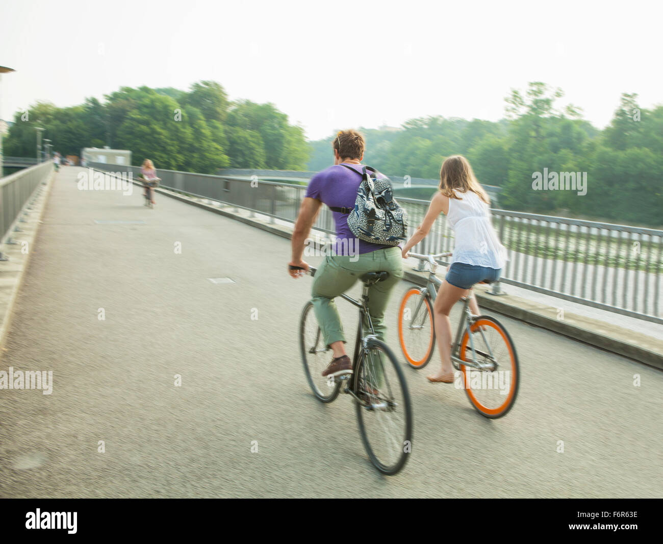 Back view of woman riding bicycle hi-res stock photography and images ...