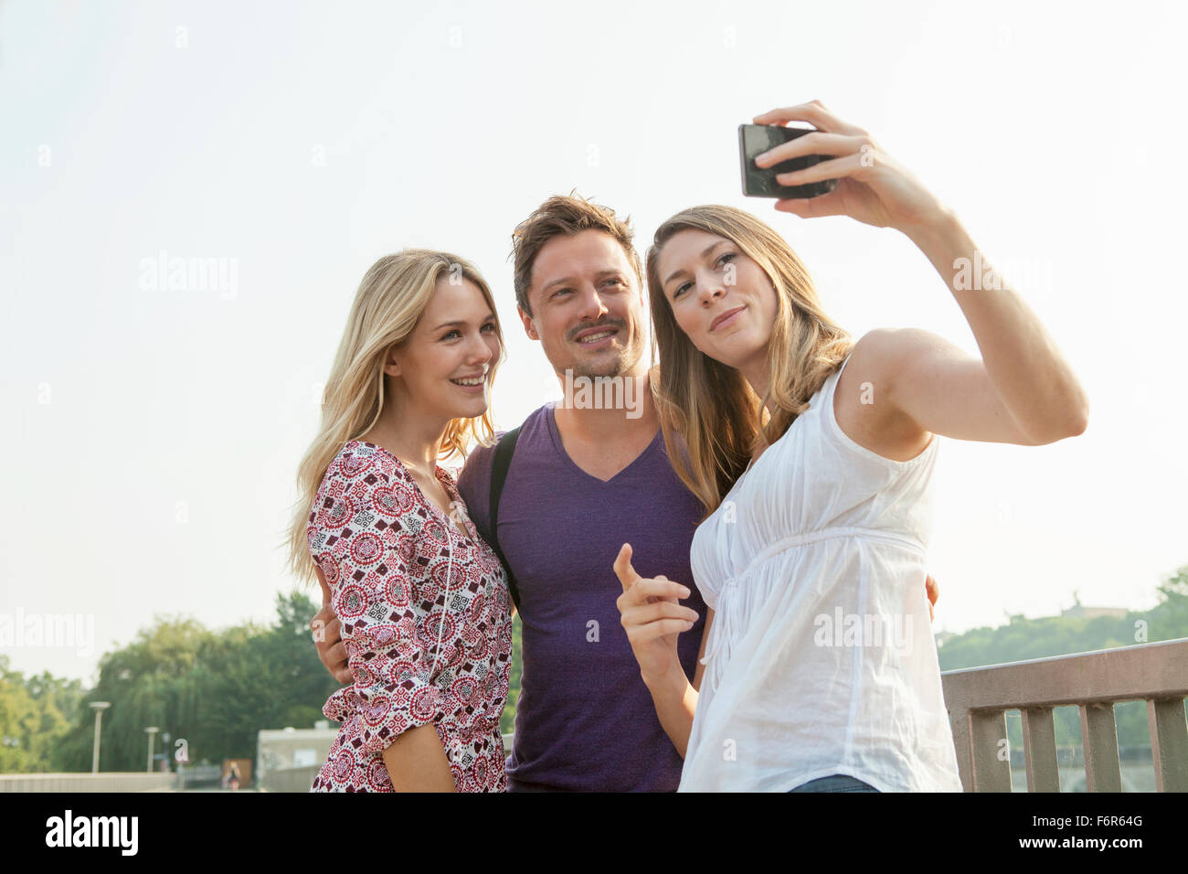 Group of friends taking self portrait outdoors Stock Photo - Alamy