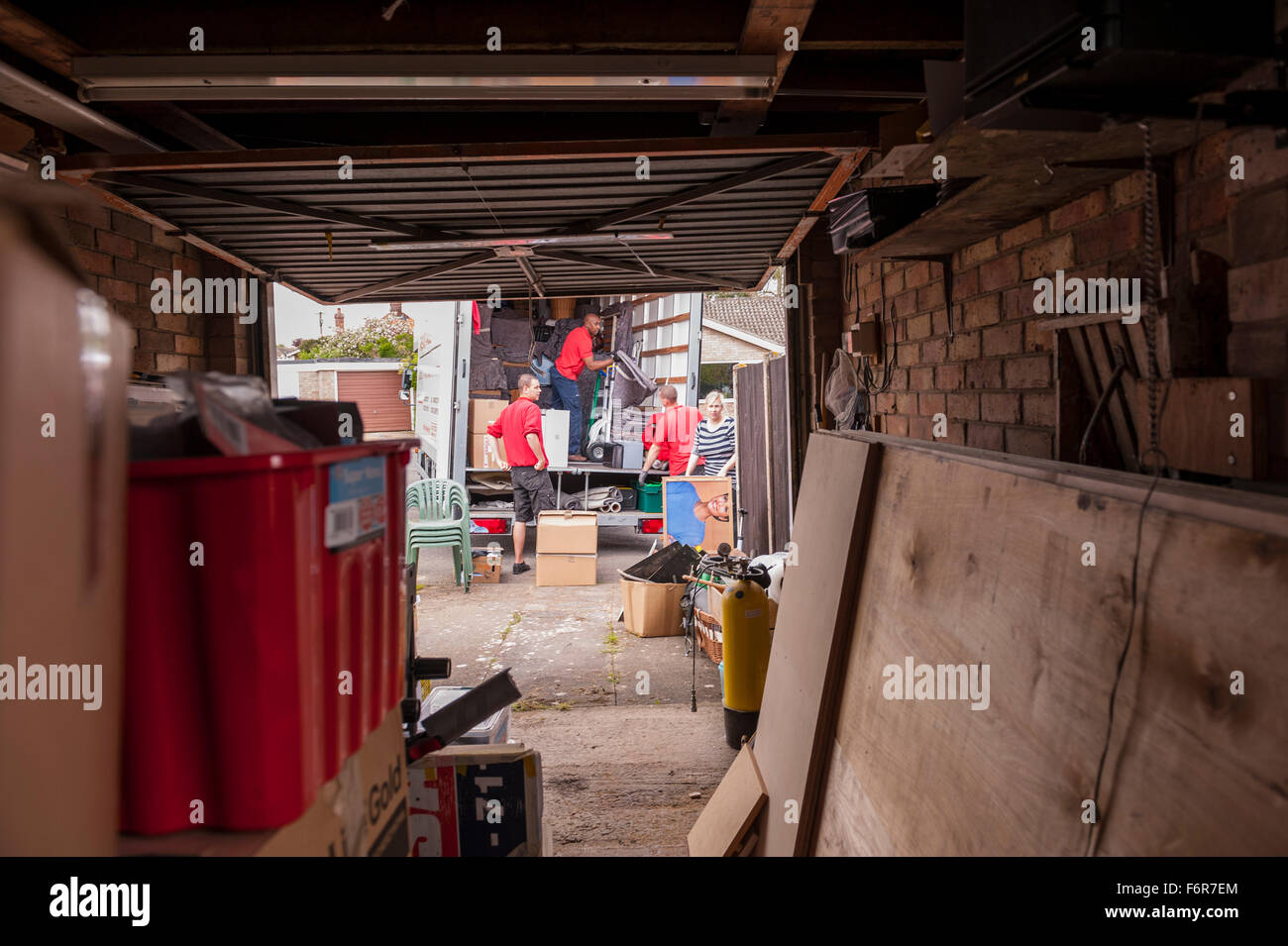 Removal men packing a removal van helping family move house in the Uk ...