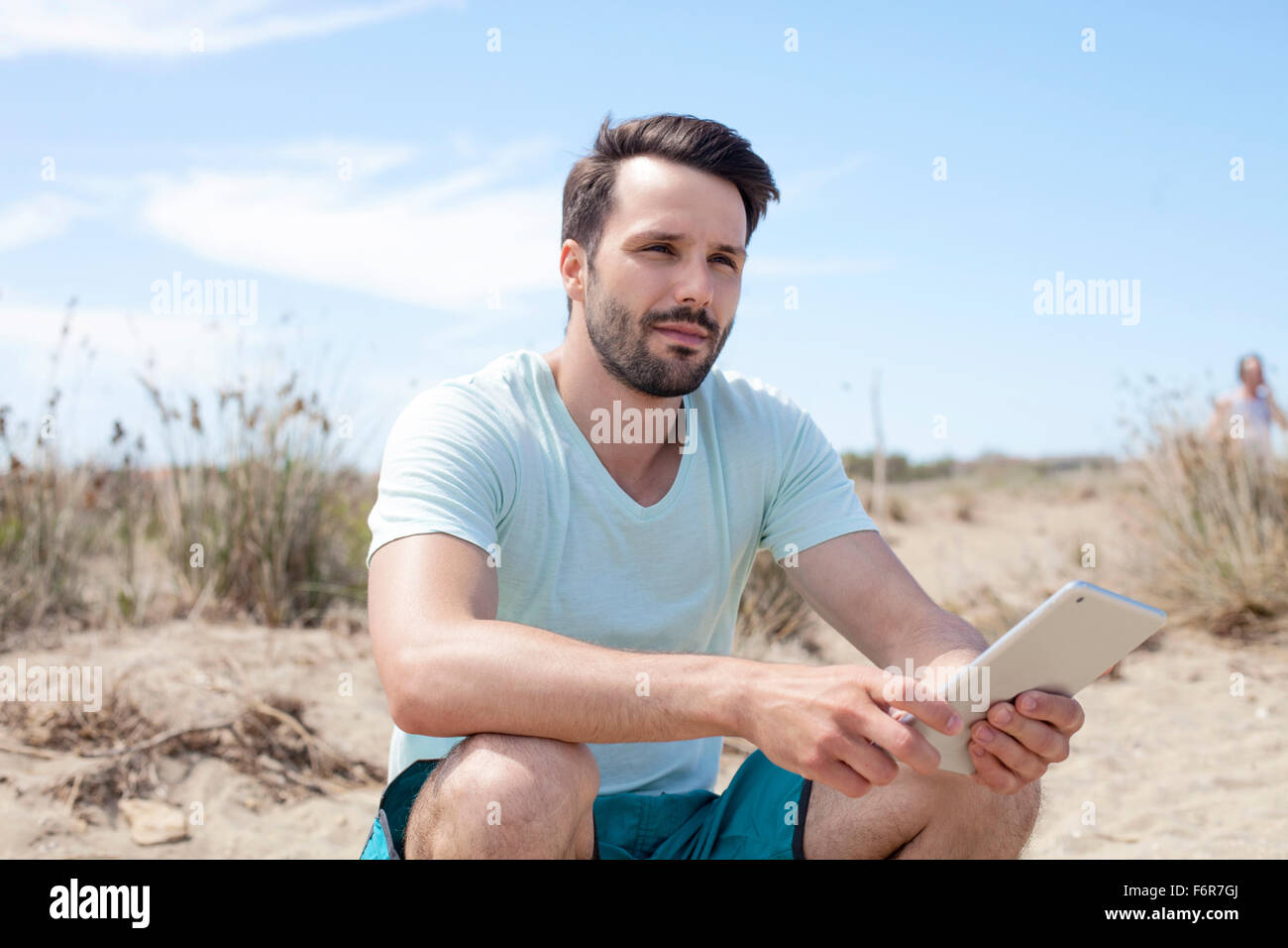 Tablet on beach hi-res stock photography and images - Alamy