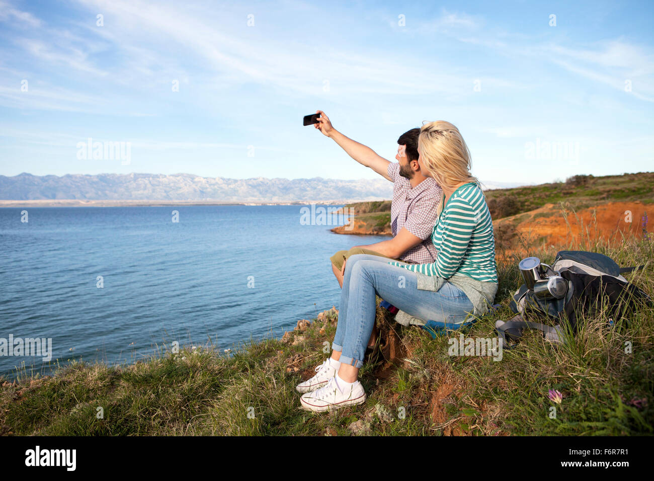 Woman on cliff taking hi-res stock photography and images - Alamy