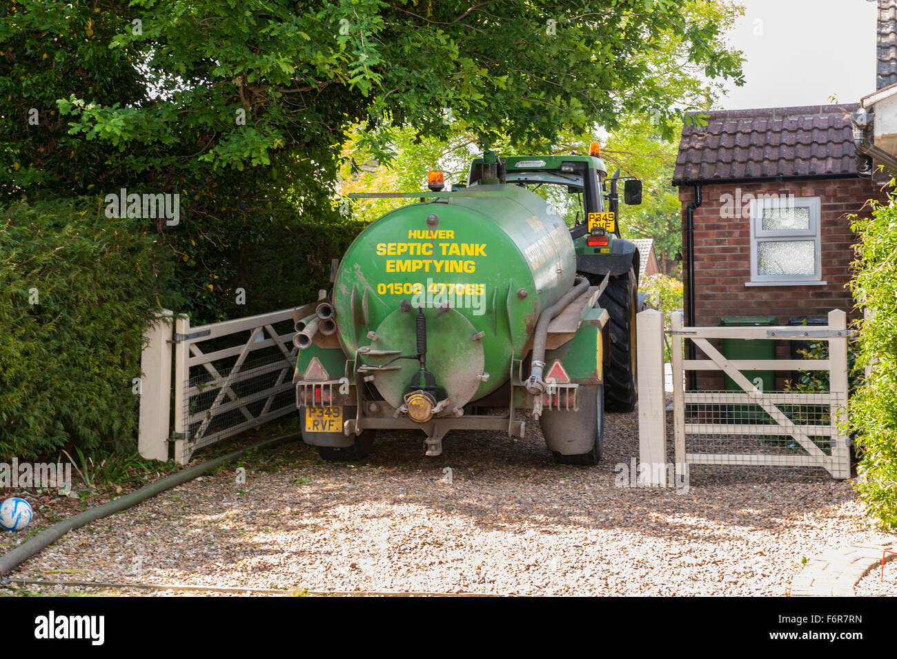 A septic tank being emptied in the Uk using a tractor and trailor Stock ...