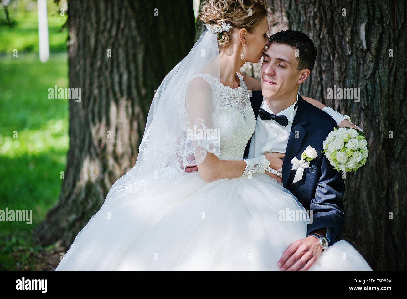 exciting elegant wedding couple walking at park in love Stock Photo - Alamy