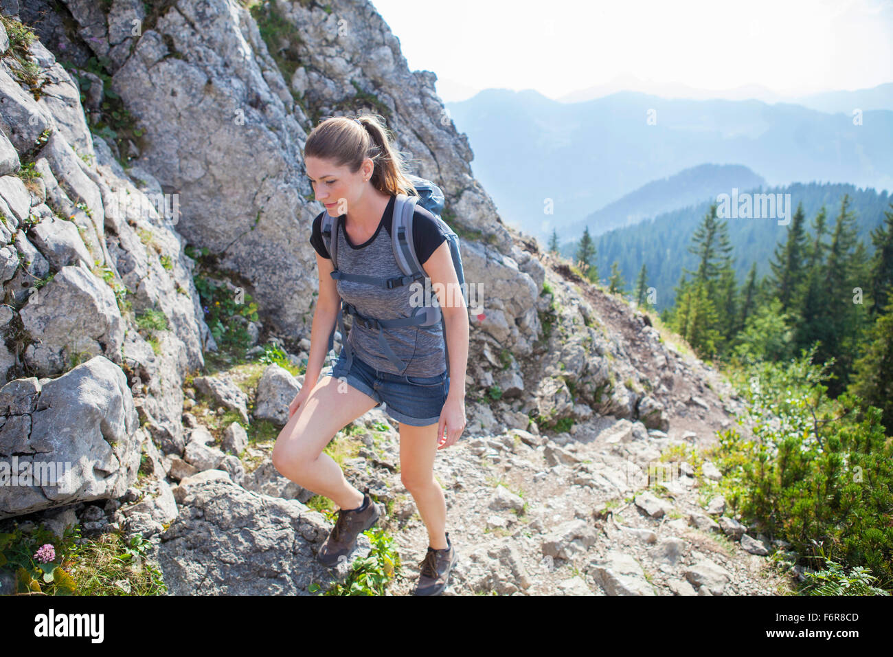 Young woman hiking in mountain landscape Stock Photo - Alamy