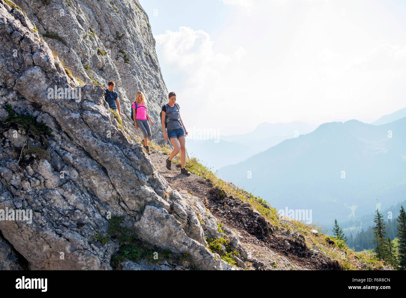 Group of friends hiking in mountain landscape Stock Photo - Alamy