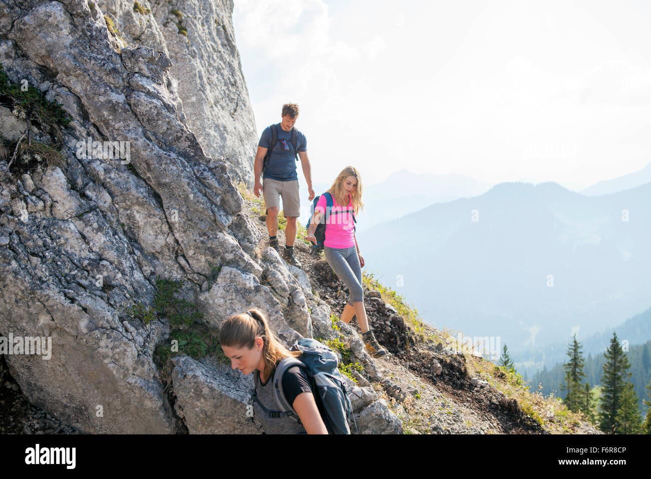 Group of friends hiking in mountain landscape Stock Photo - Alamy