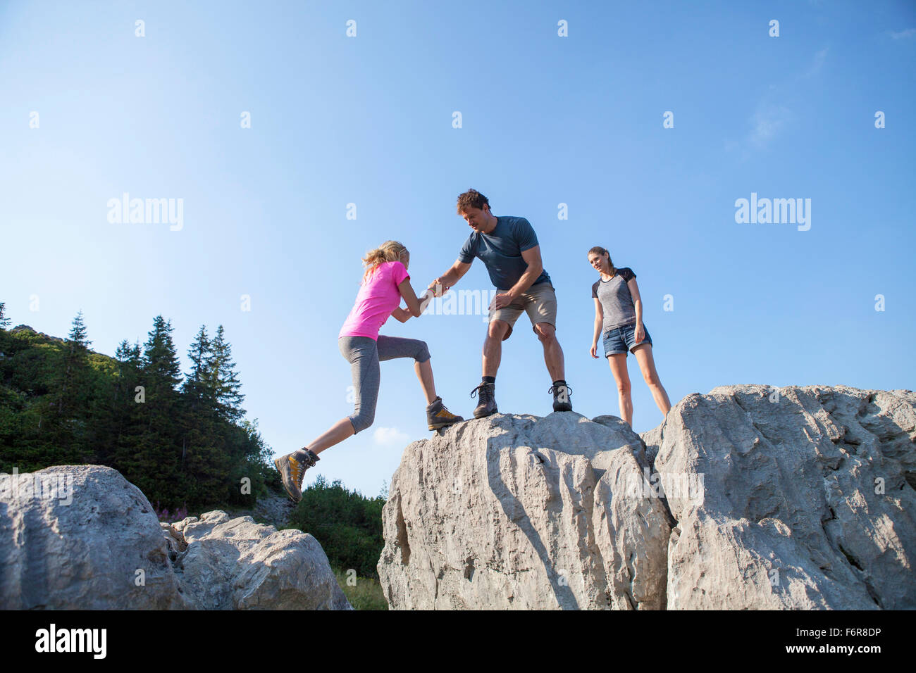 Group of friends hiking in mountain landscape Stock Photo - Alamy