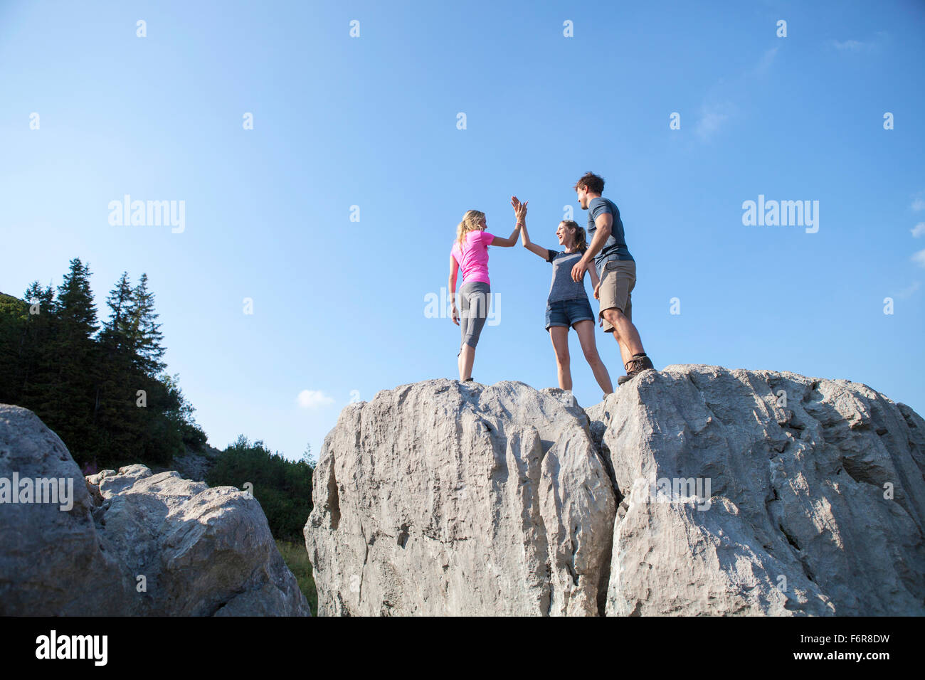 Group of friends hiking in mountain landscape Stock Photo - Alamy