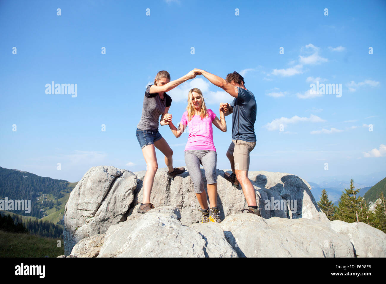 Group of friends having fun in mountain landscape Stock Photo - Alamy