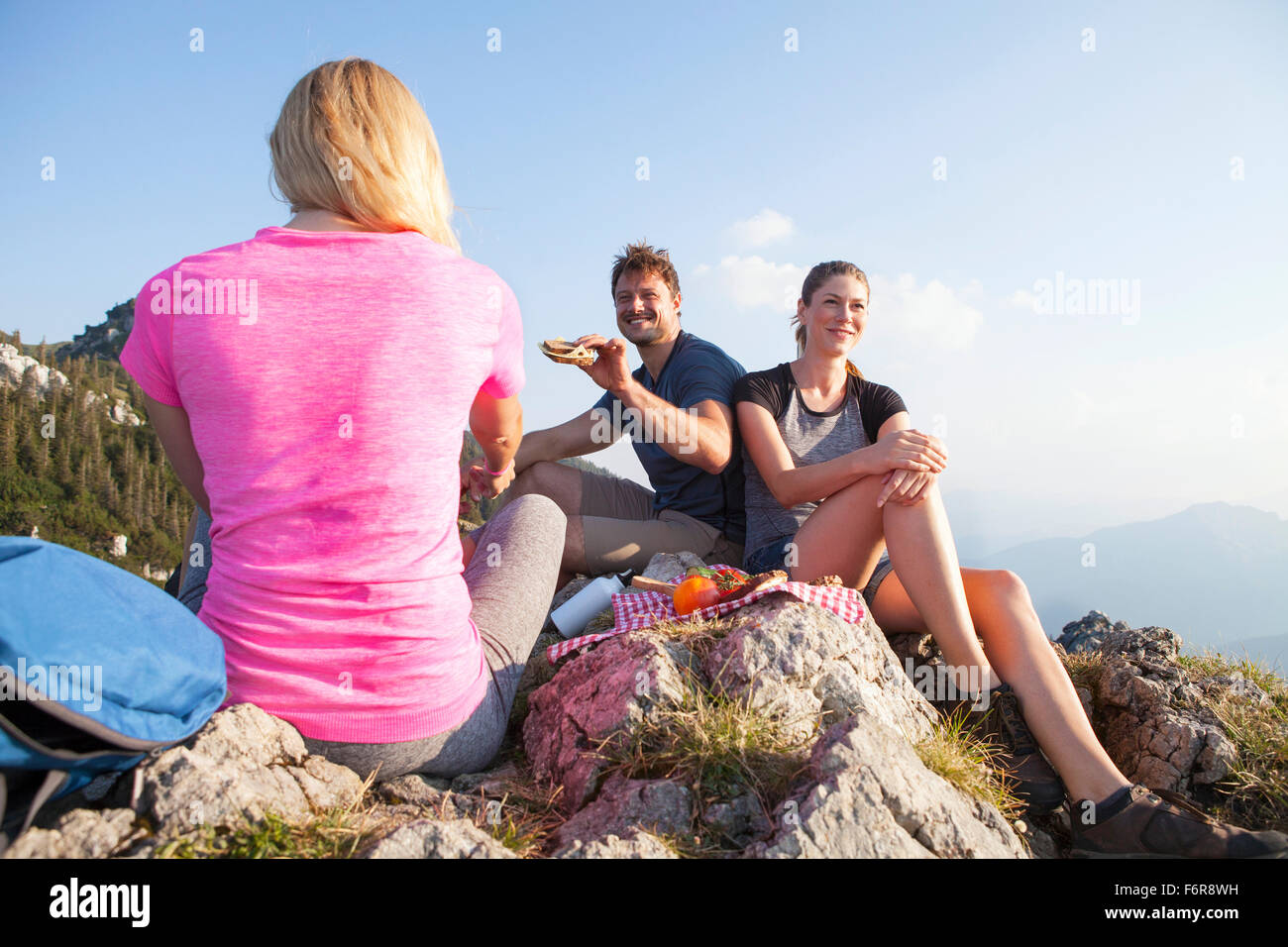 Group of friends resting in mountain landscape Stock Photo - Alamy