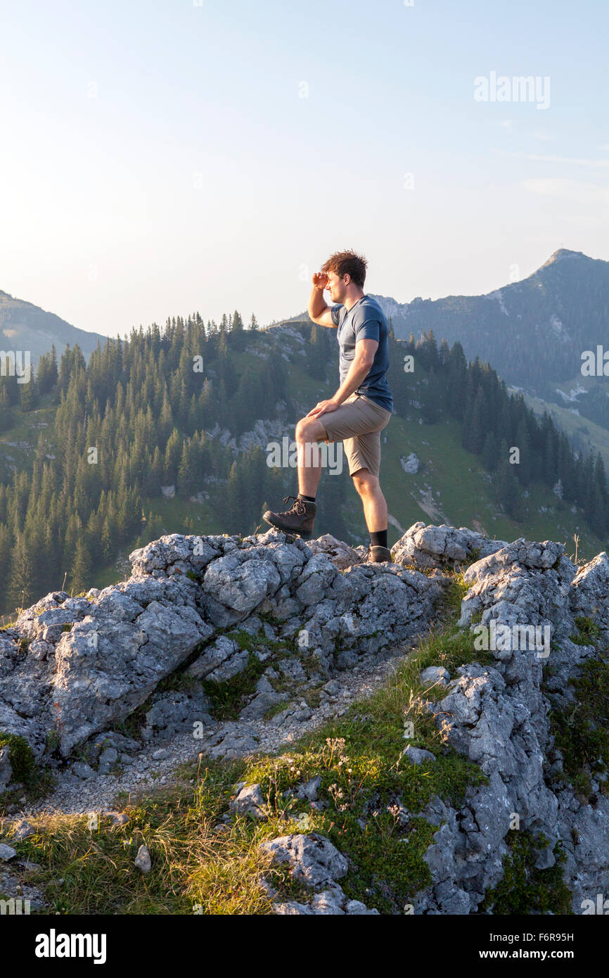 Young man overlooking mountain landscape Stock Photo - Alamy