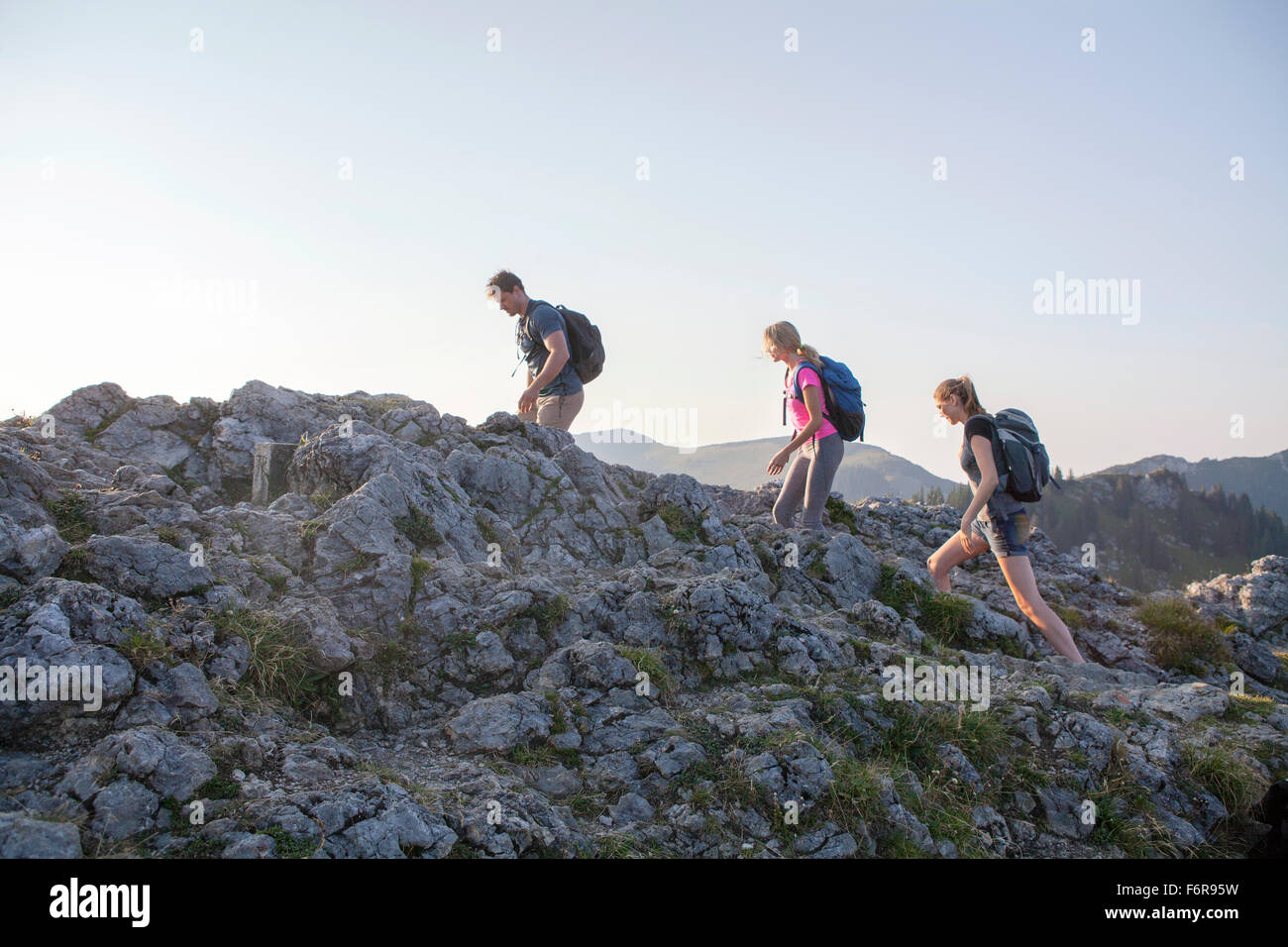 Group of friends hiking in mountain landscape Stock Photo - Alamy