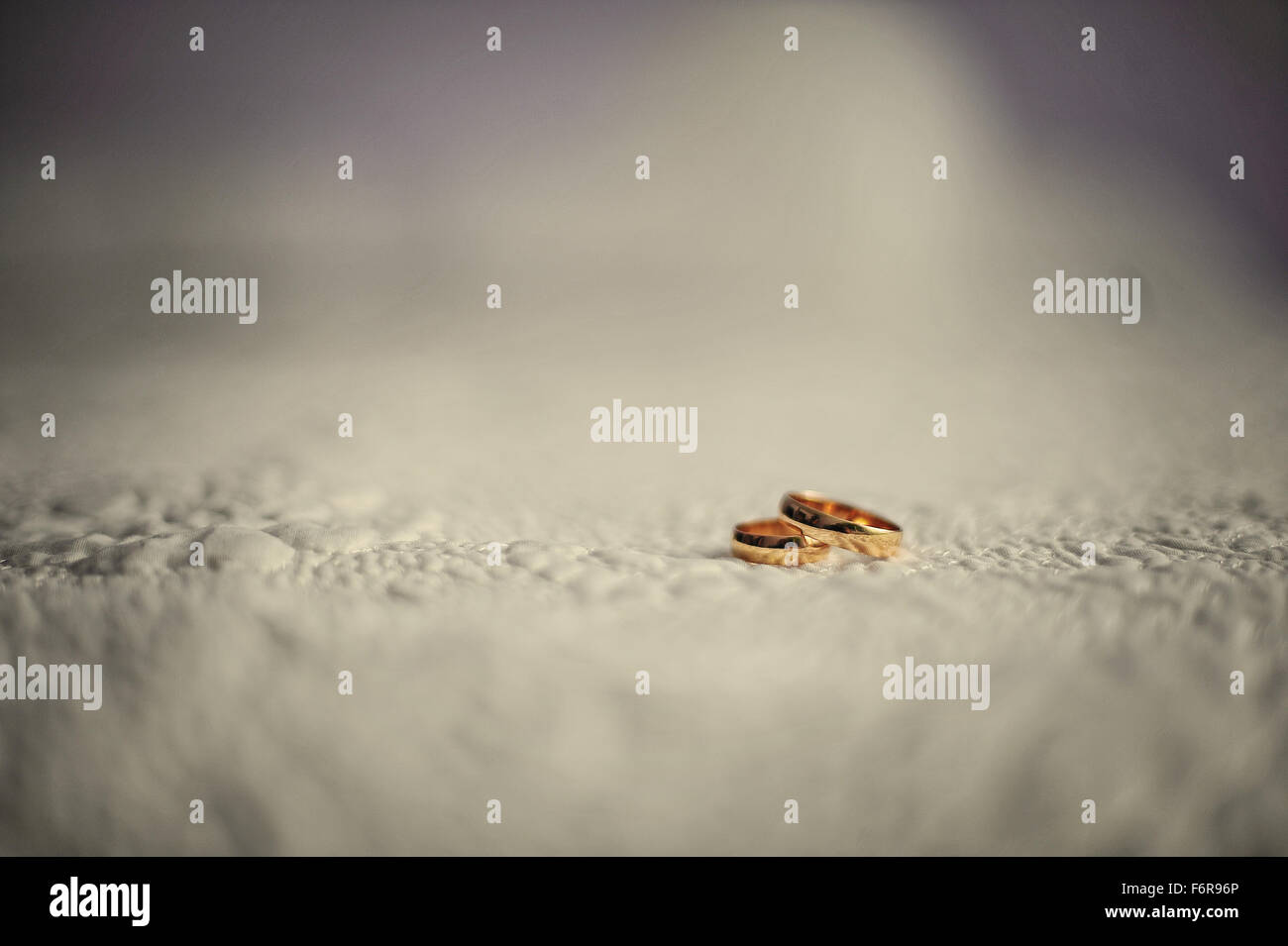 Two engagement wedding rings on textile background Stock Photo - Alamy