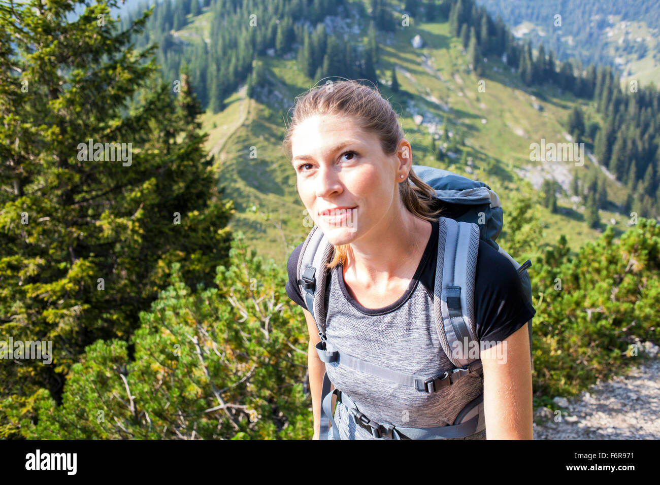 Young woman hiking in mountain landscape Stock Photo - Alamy
