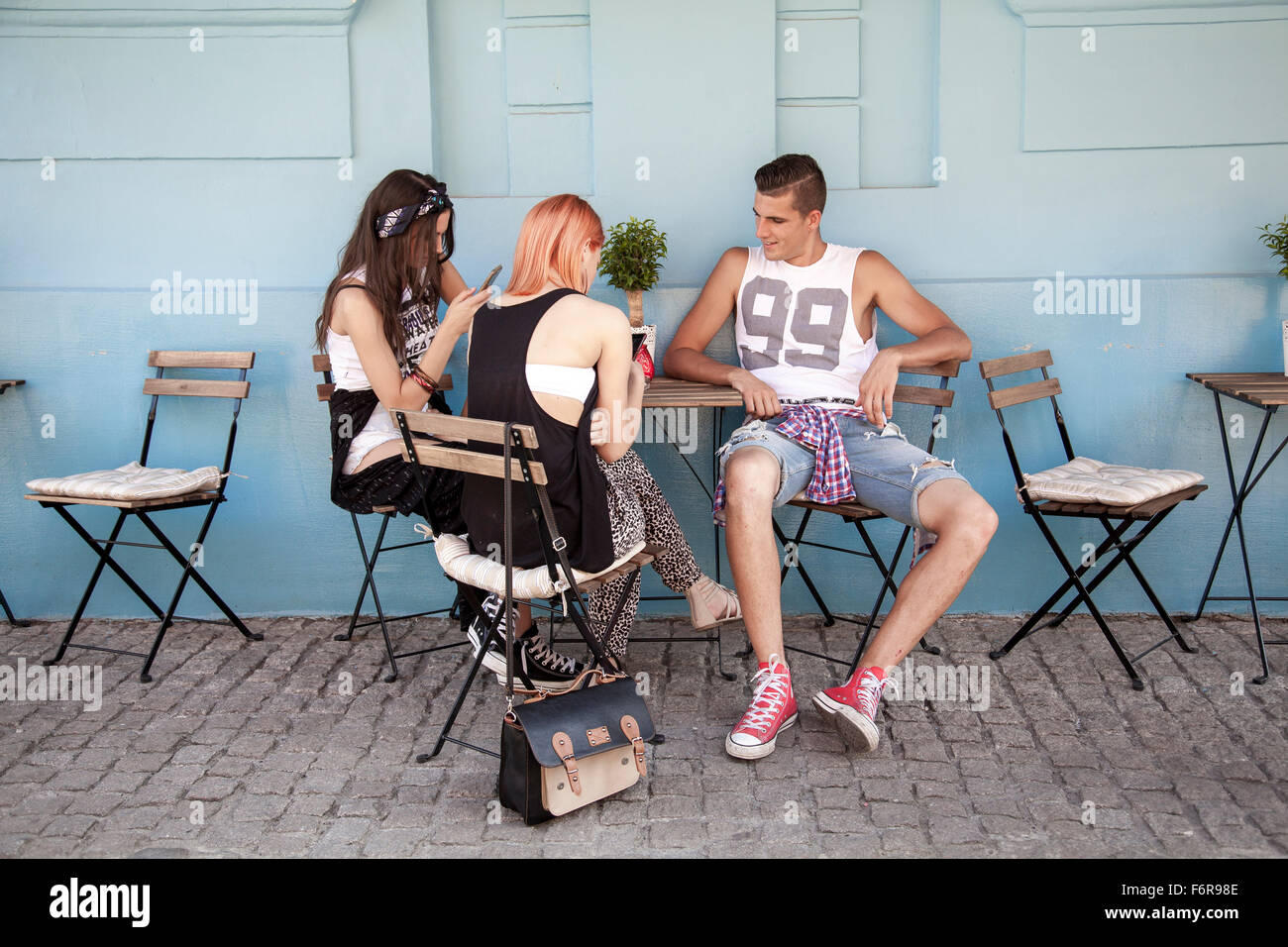 Young people in hippie style fashion in restaurant outdoors Stock Photo ...