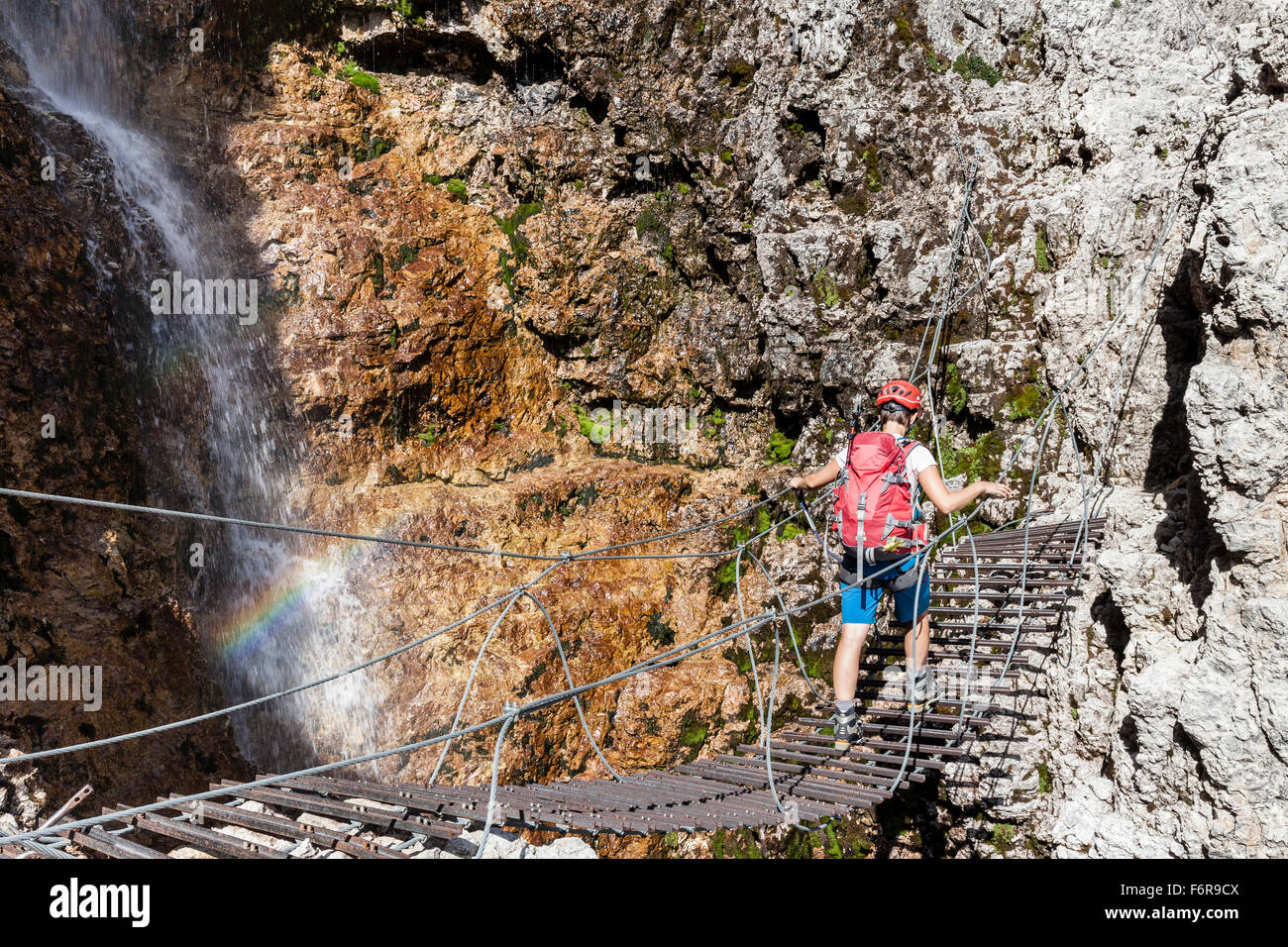Climbers on suspension bridge, with waterfall, via ferrata Vallonsteig ...