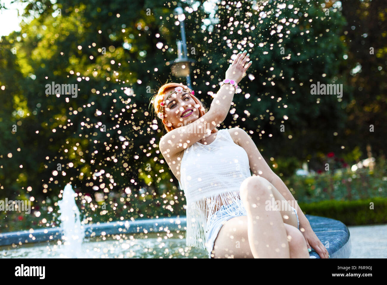 Young woman in hippie style fashion splashing water Stock Photo - Alamy