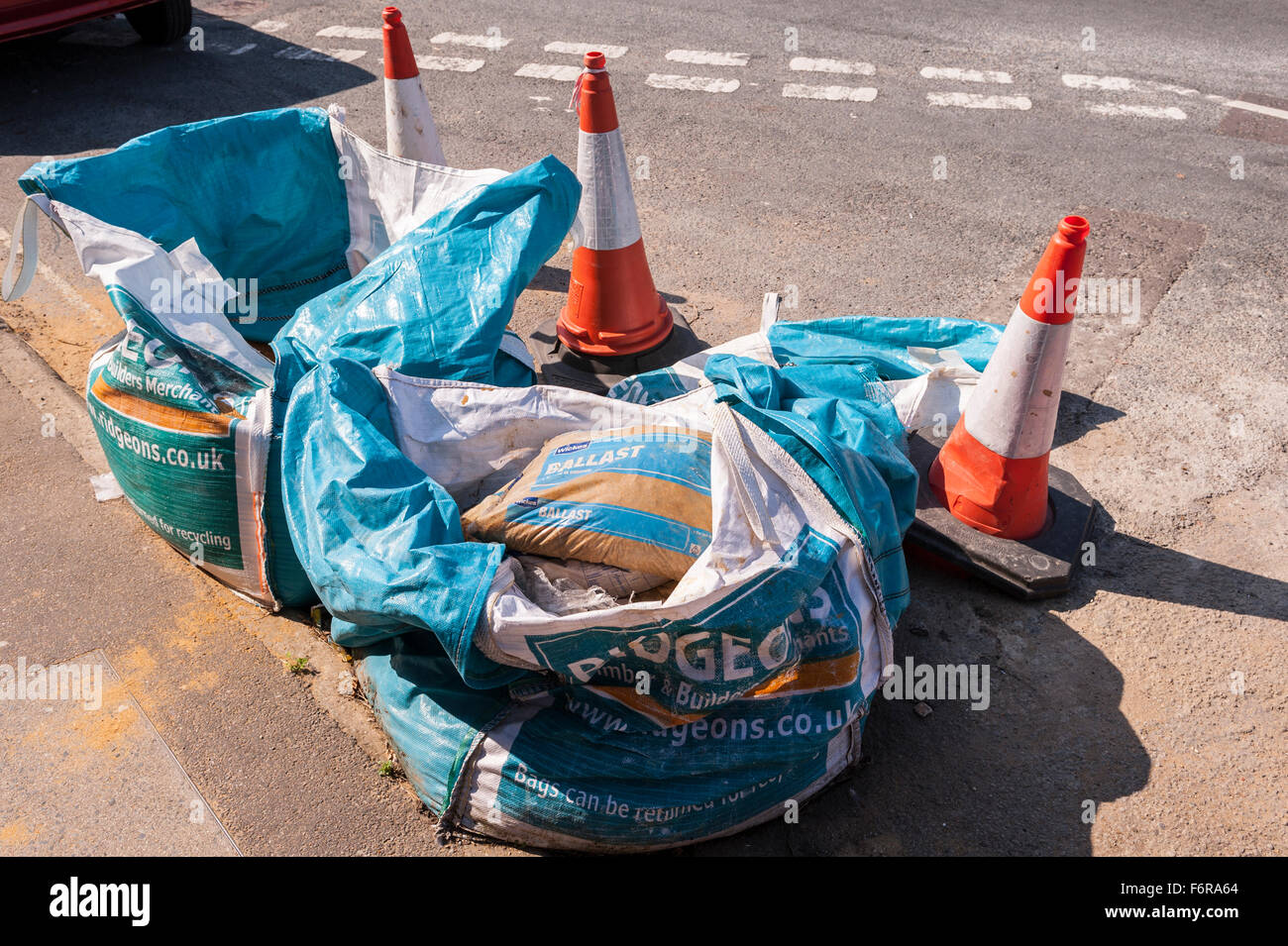Bags used by building supplier at side of road by building site in the ...