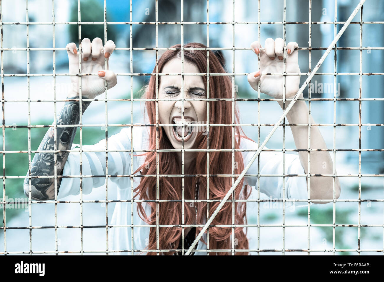 Young woman behind bars hi-res stock photography and images - Alamy