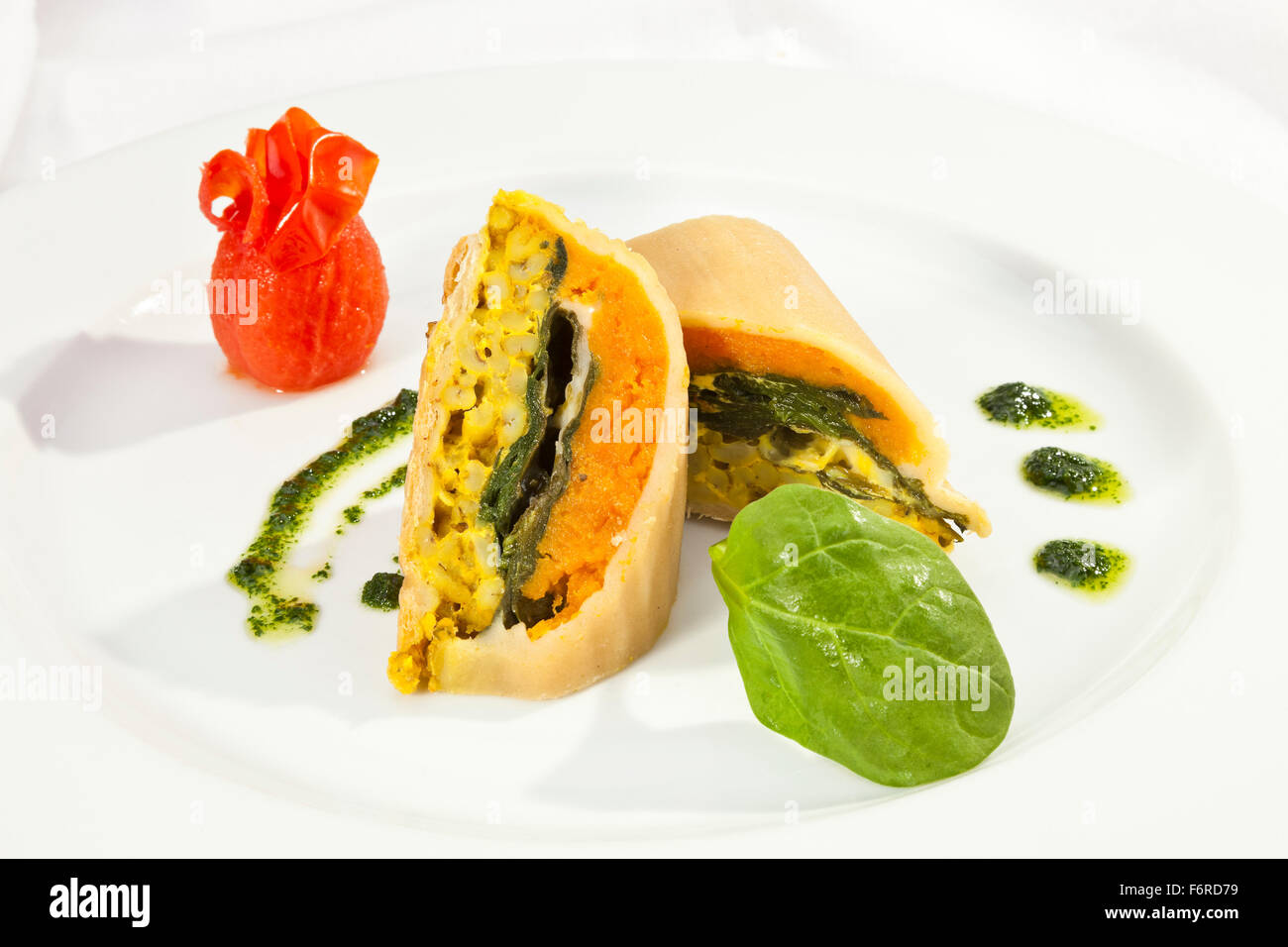 Vegetarian roulade with spinach, carrot and curry rice Stock Photo - Alamy