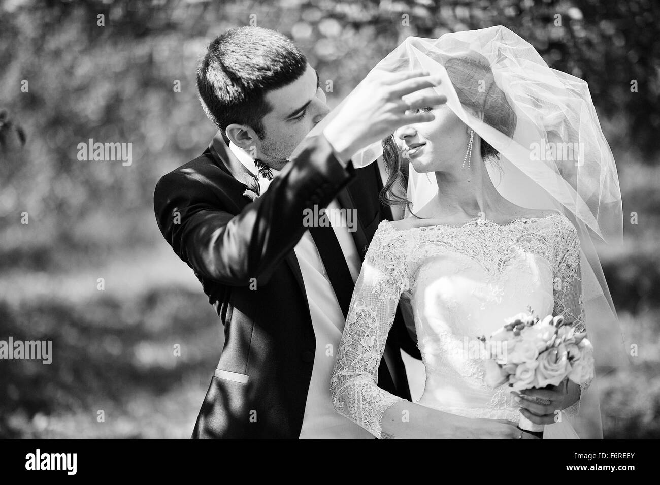 groom looking at bride from veil Stock Photo - Alamy