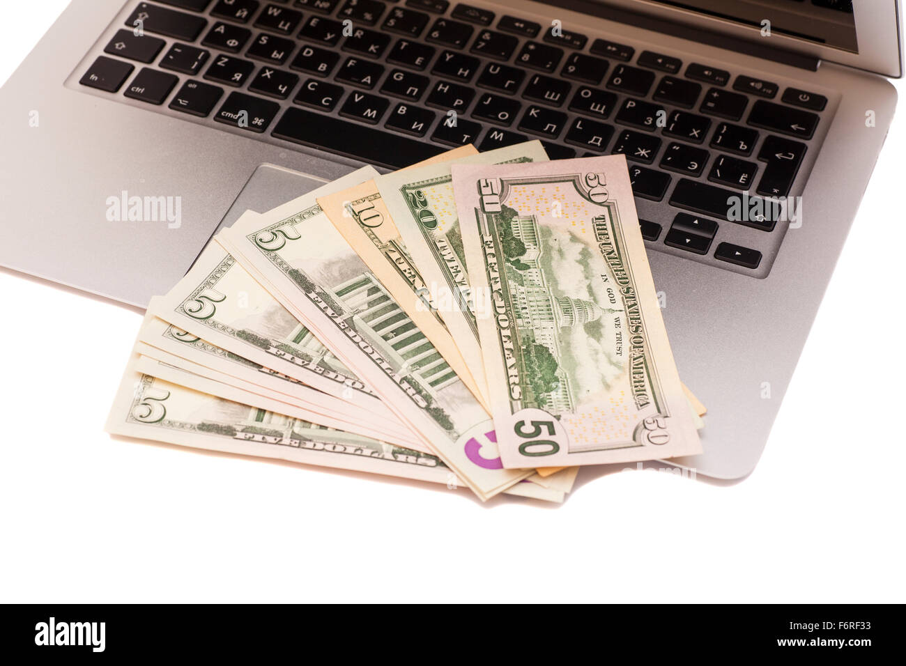 Open Laptop With Dollars money Stock Photo - Alamy