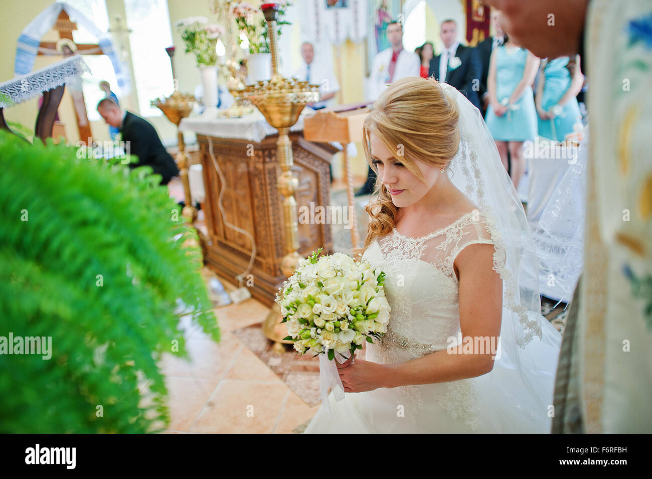 Blonde bride at church Stock Photo - Alamy