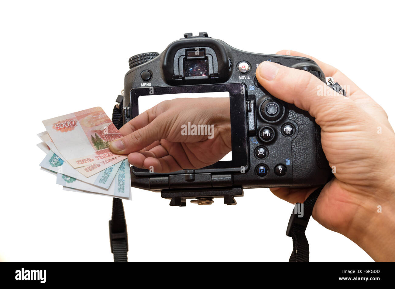 The photo depicts a camera and a hand full of money Stock Photo - Alamy