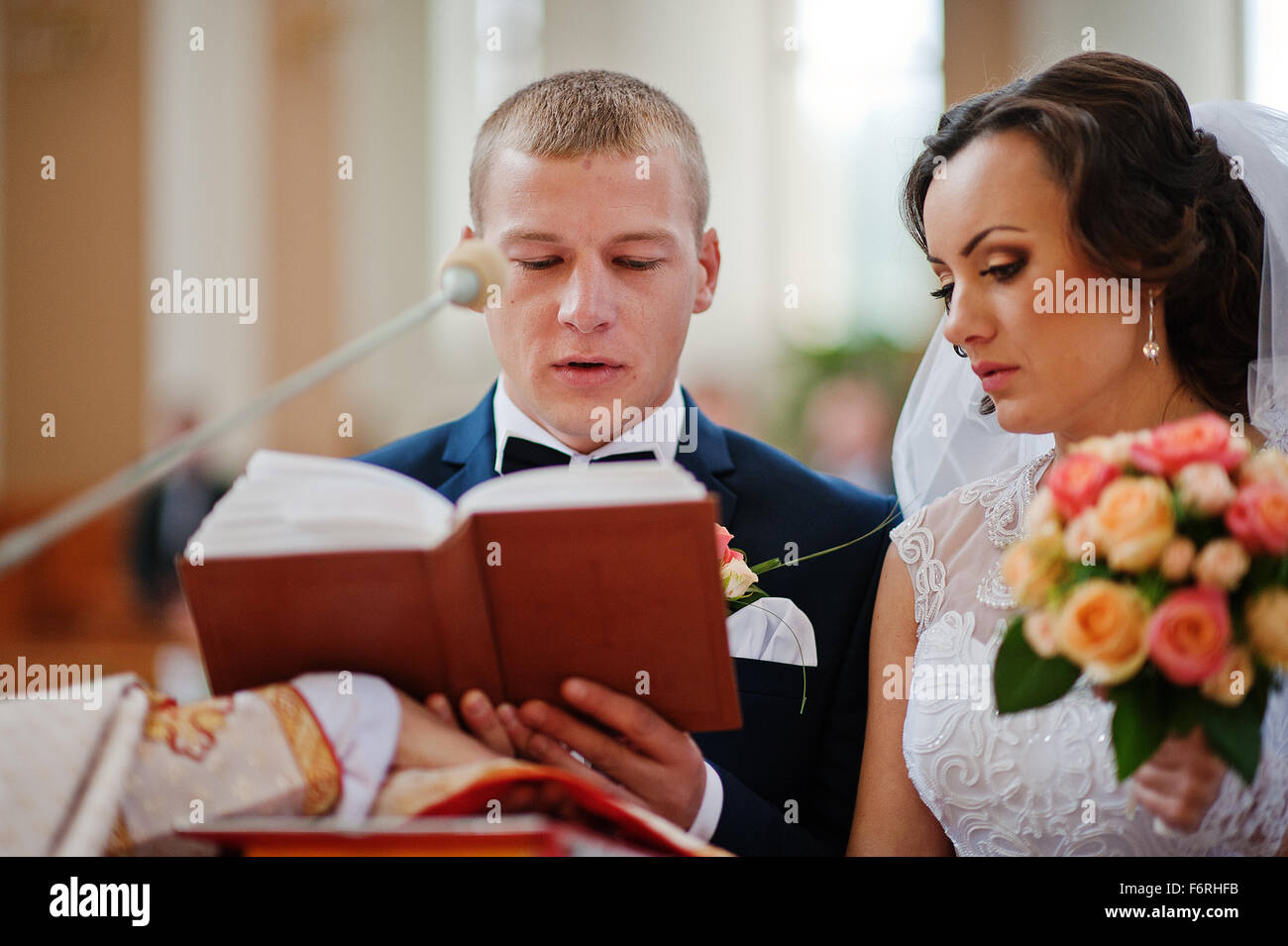 newlywed give oath in church holding a bible Stock Photo - Alamy