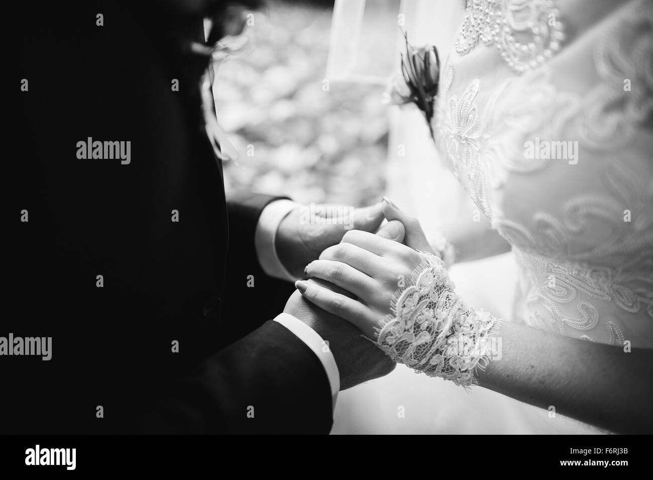 hand in hand of wedding couple Stock Photo - Alamy