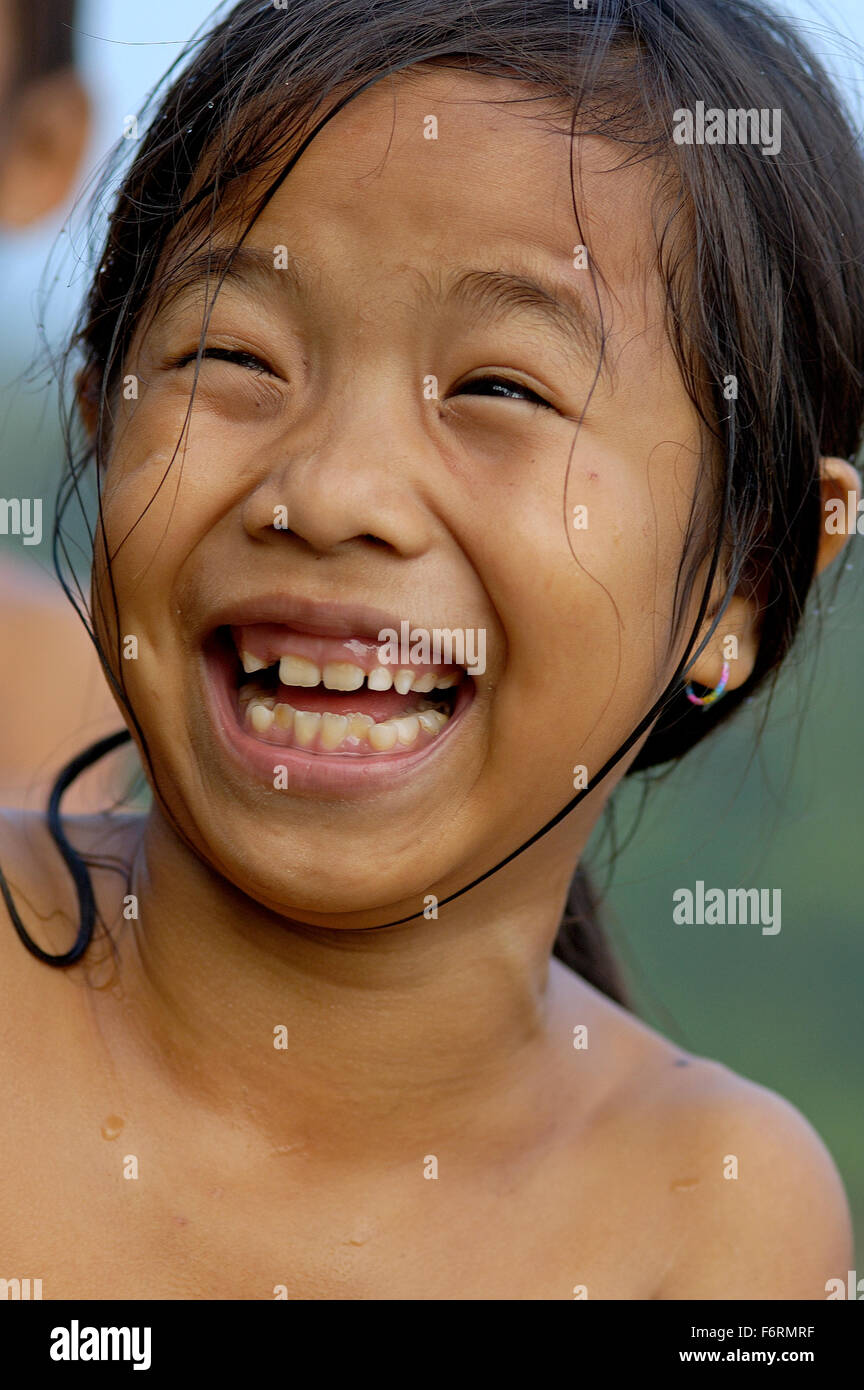 Smiling Laos girl in her traditional village along the Mekong river ...