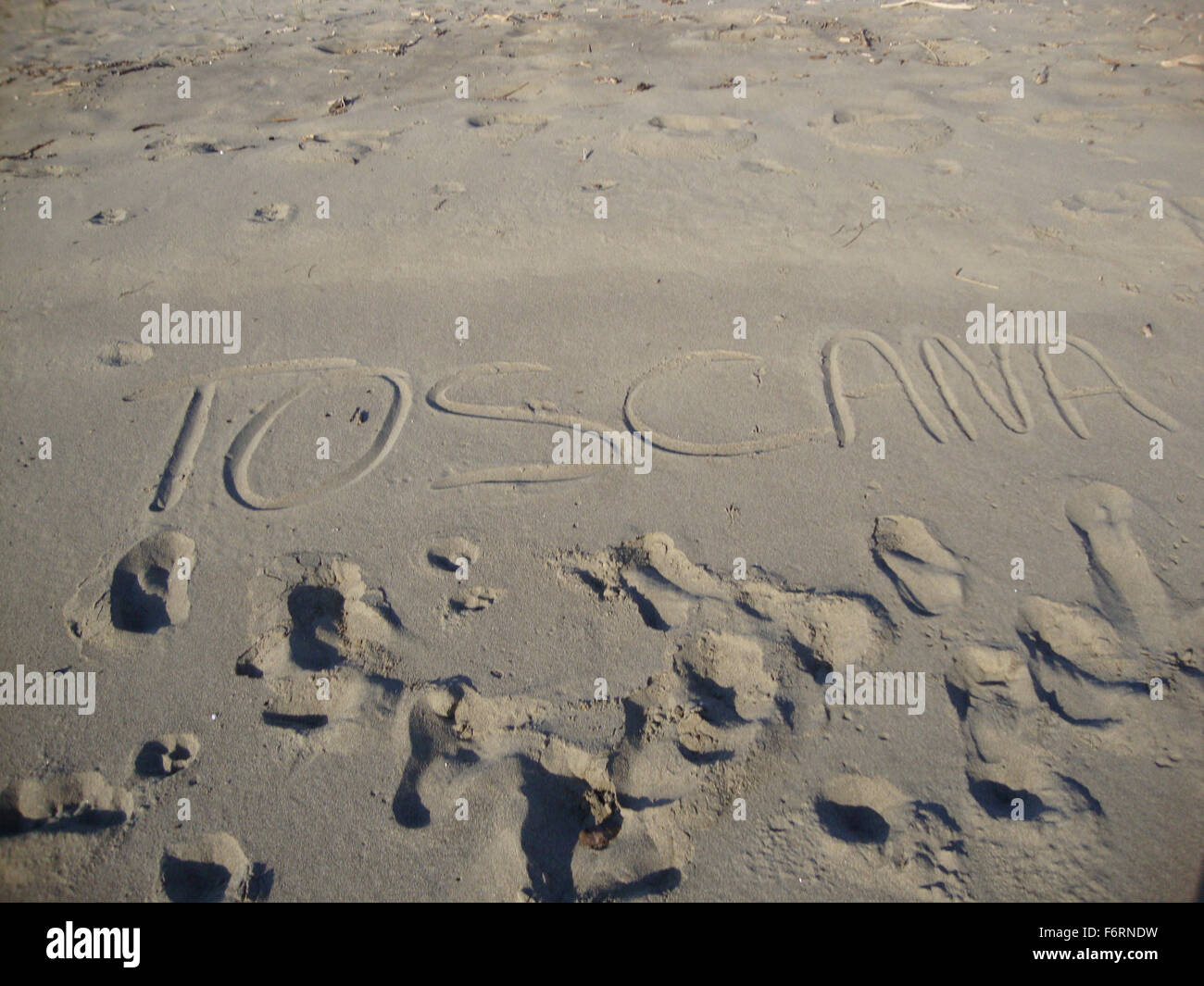 Toscana written in Sand Stock Photo - Alamy