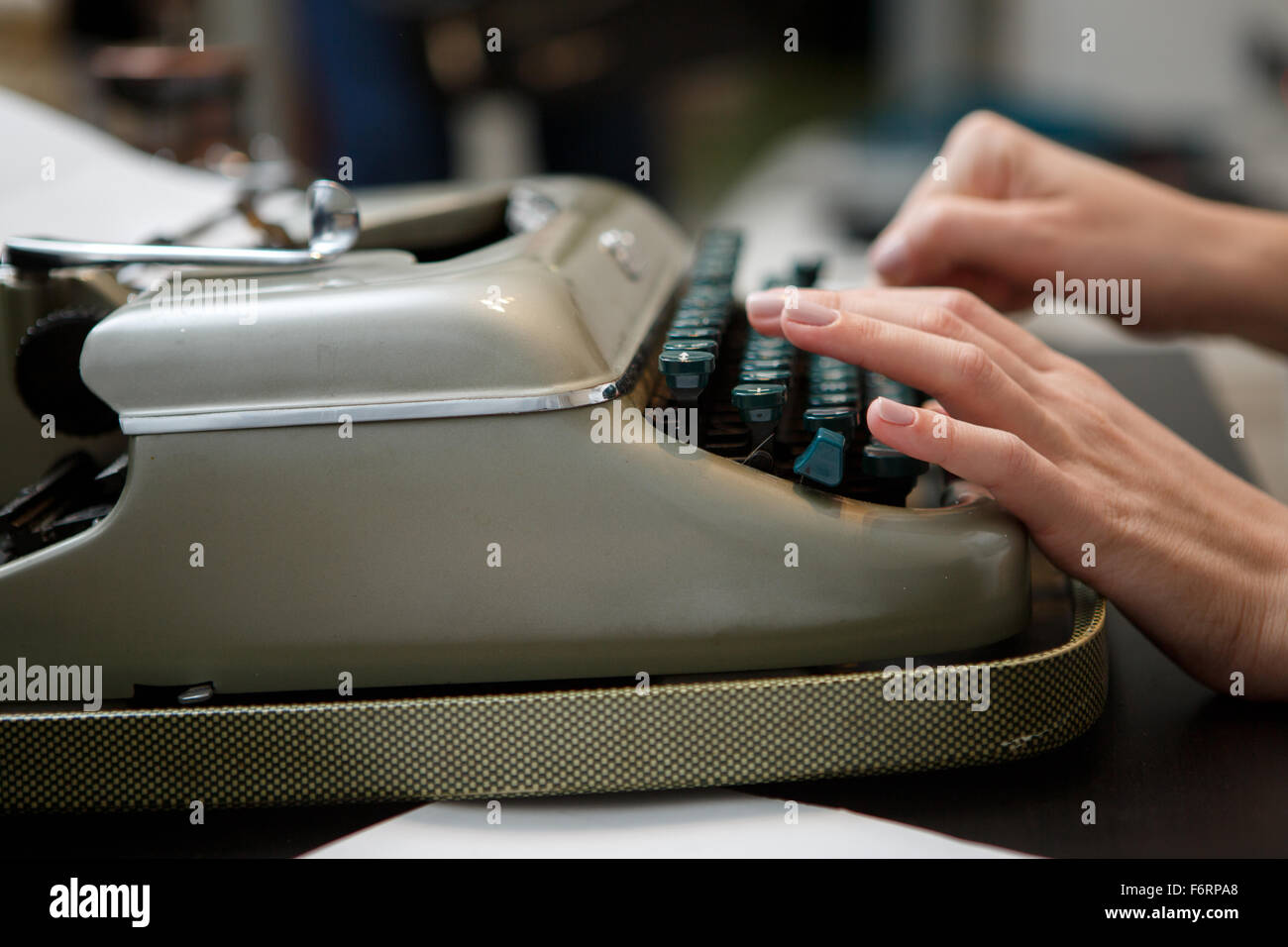 closeup of woman typing with old typewriter side view Stock Photo - Alamy