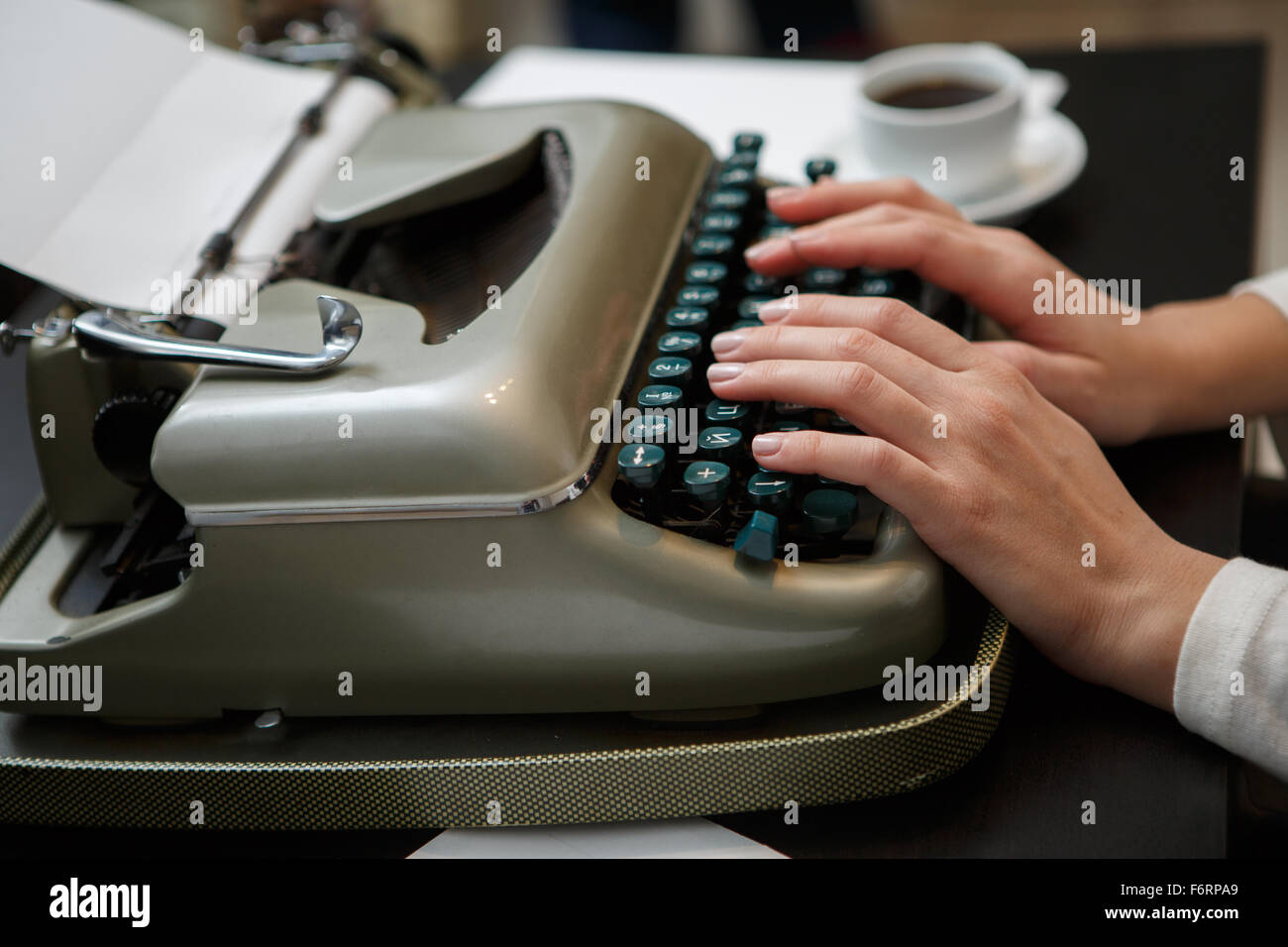 closeup of woman typing with old typewriter side view Stock Photo - Alamy