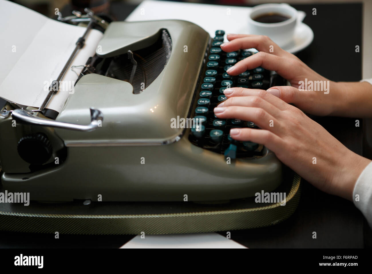 closeup of woman typing with old typewriter side view Stock Photo - Alamy