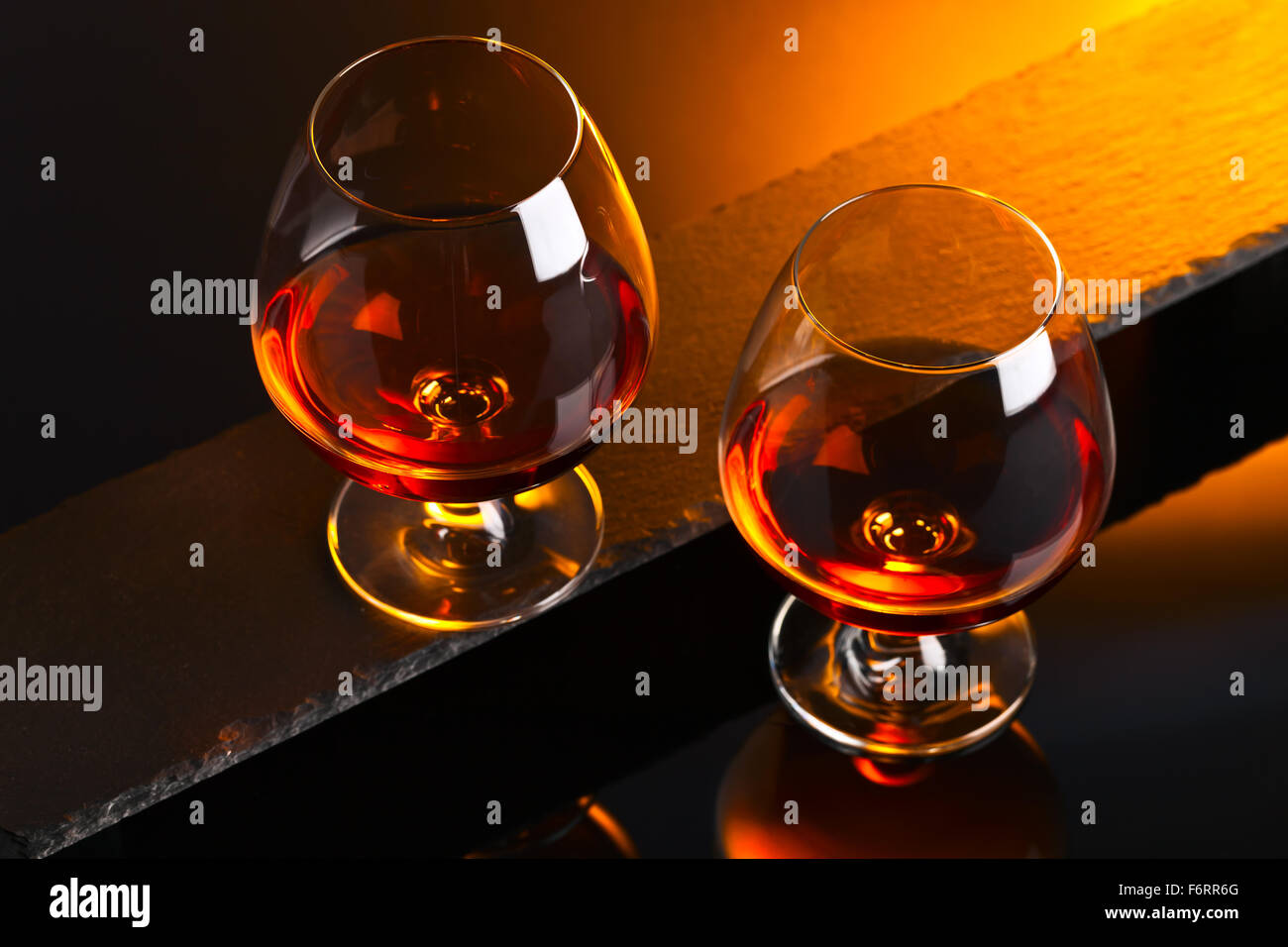 Snifter with brandy on a dark background Stock Photo - Alamy