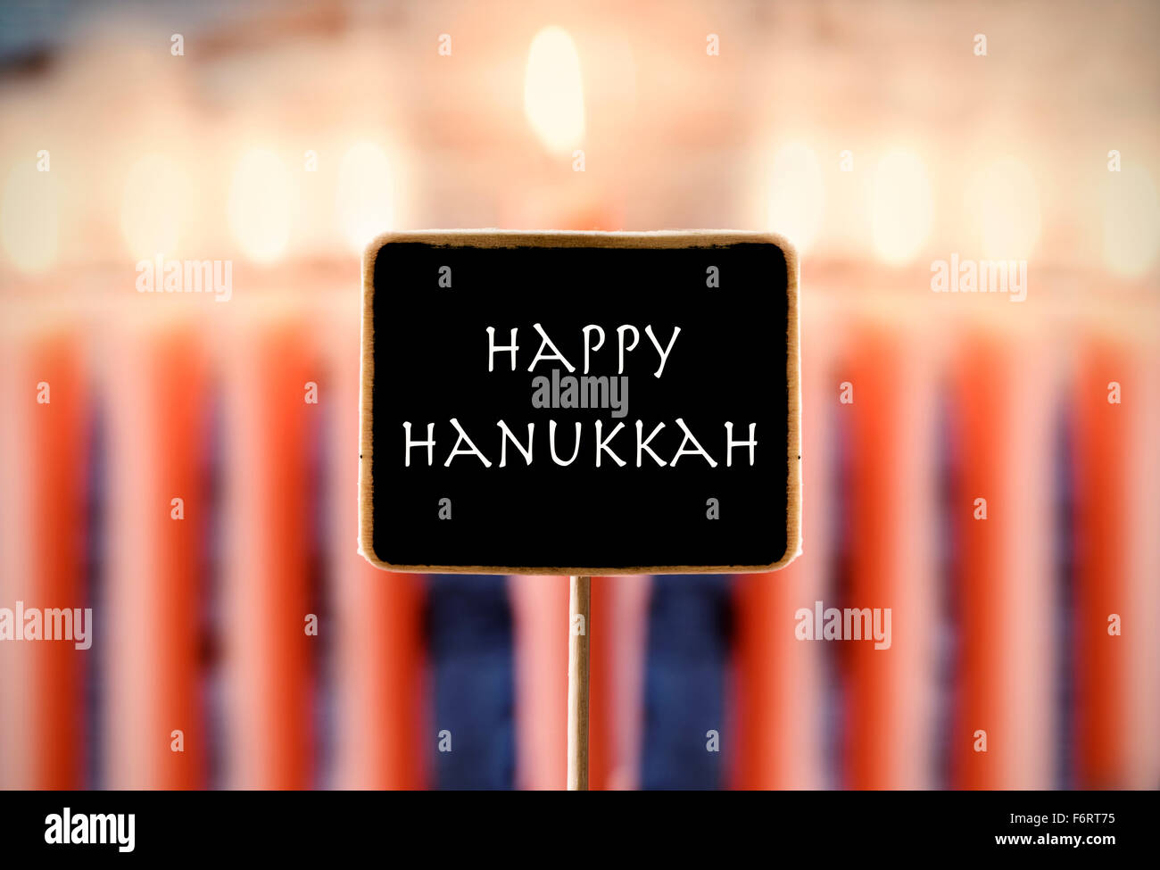 closeup of a chalkboard with text happy Hanukkah and a menorah with ...