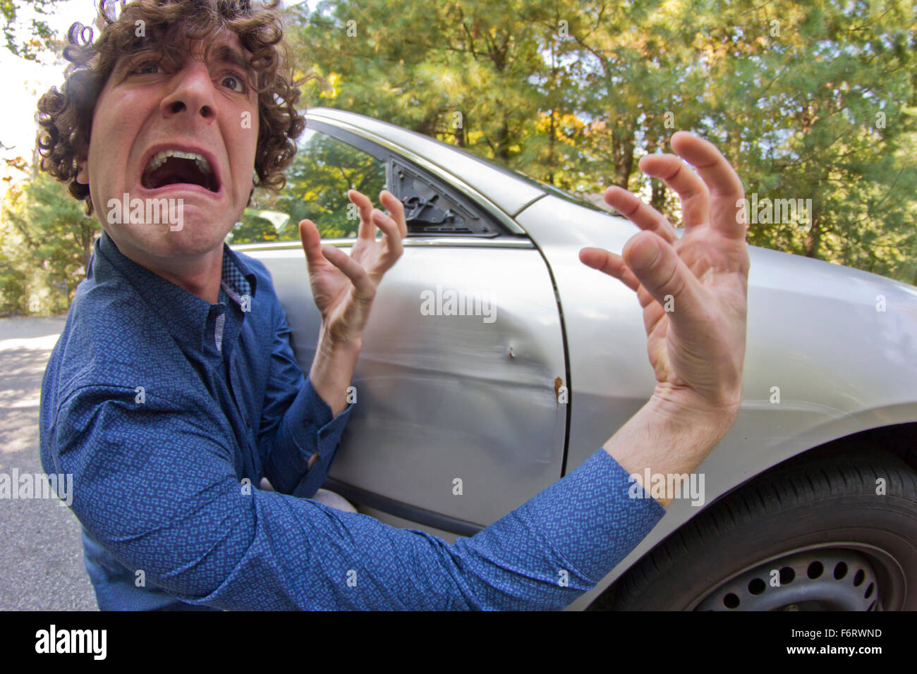 Silly man gets into car crash and makes ridiculous face Stock Photo - Alamy